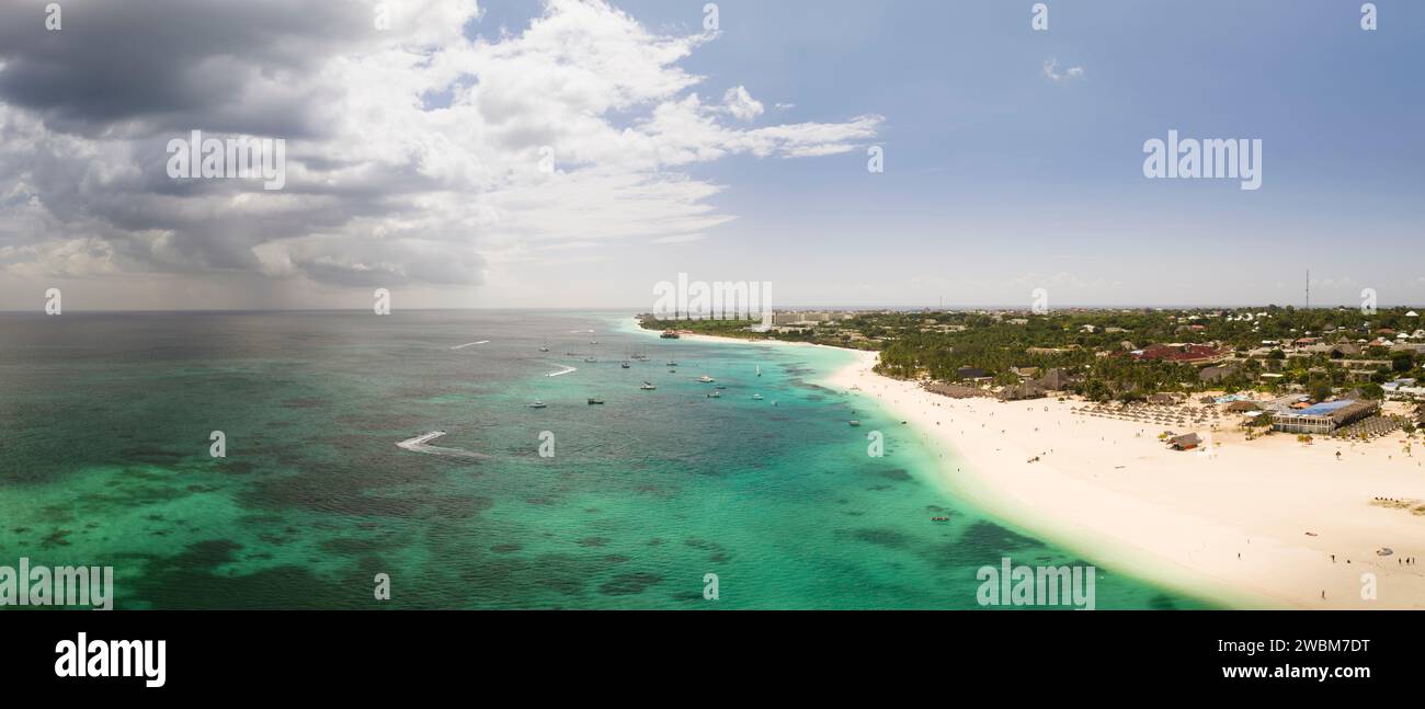 Typical Zanzibar beach where tourists and locals mix together of colors ...