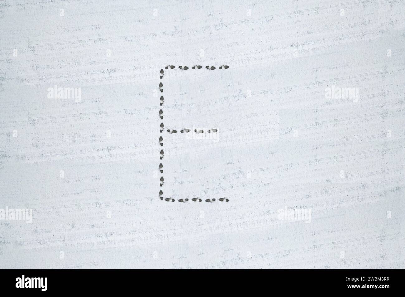 The letter E written in the snow. Winter writings Stock Photo - Alamy