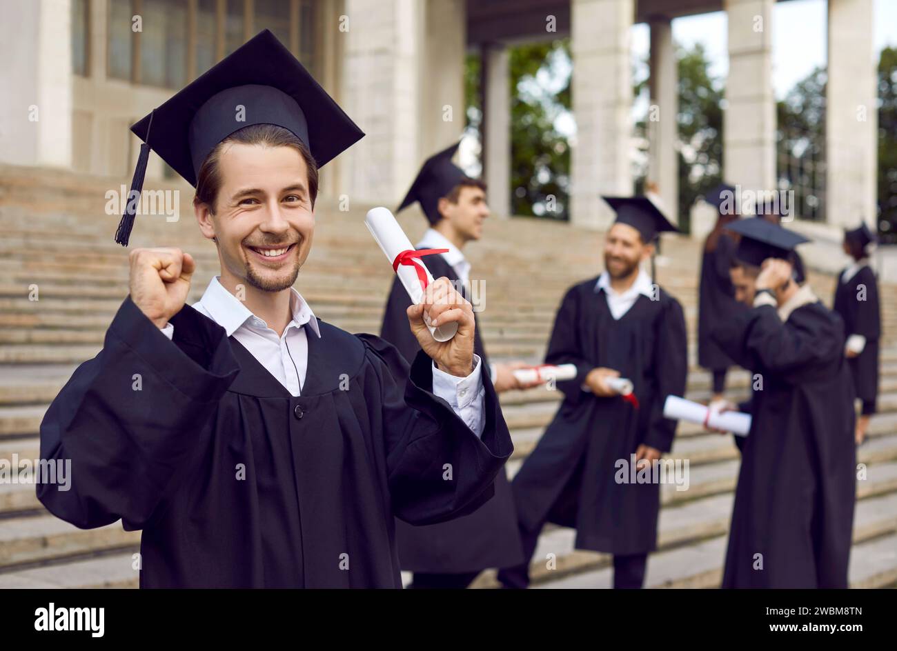 Happy smiling graduate students giving high five to each other ...