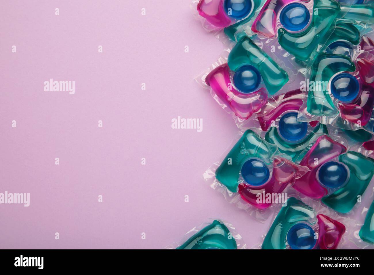 Laundry capsule detergent pods for washing clothes on purple background ...