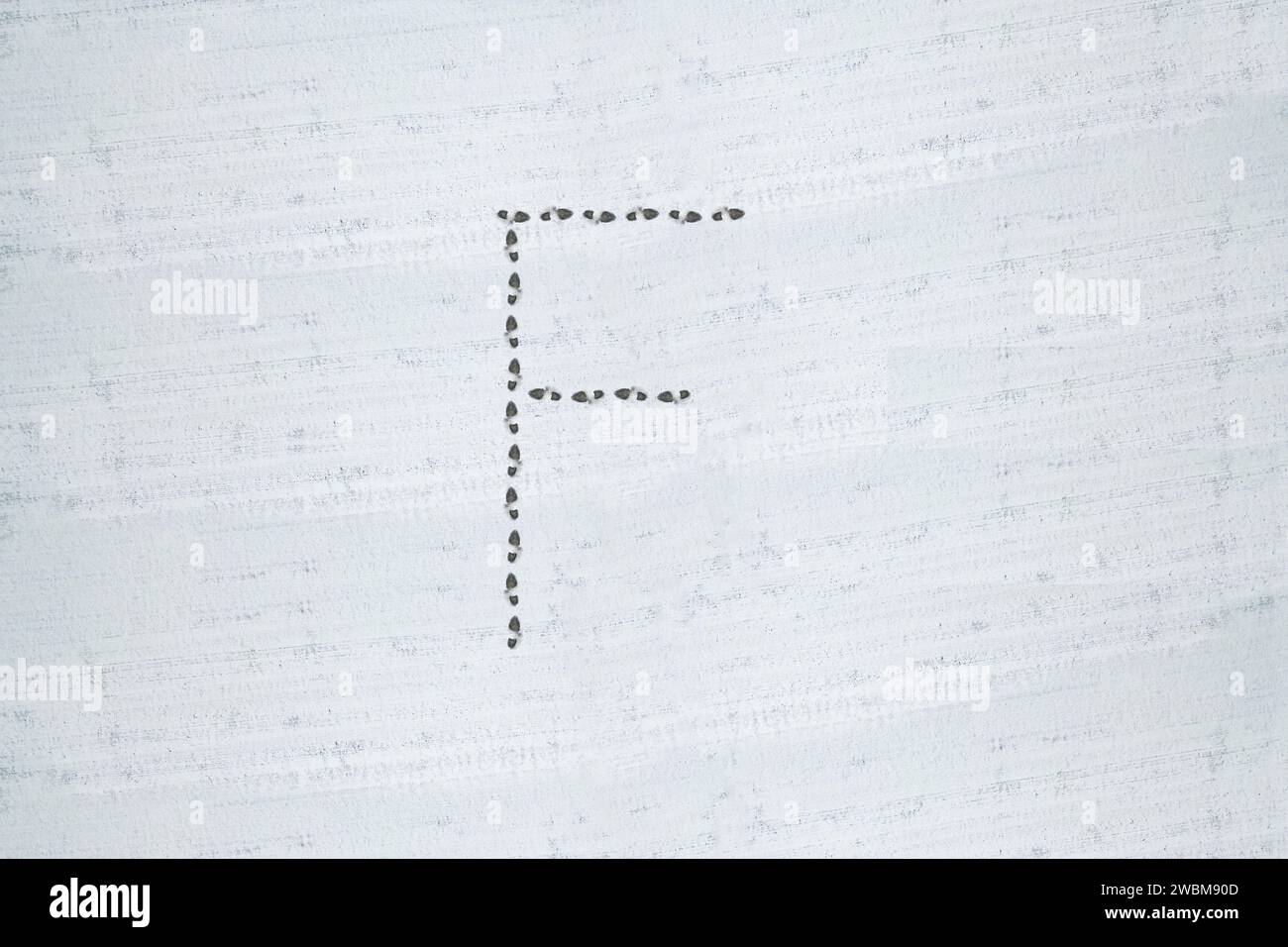 The letter F written in the snow. Winter writings Stock Photo - Alamy