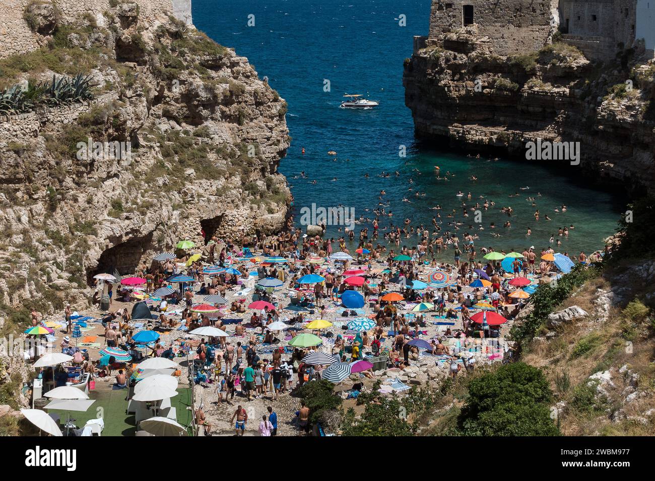 Italy, Puglia, Polignano a Mare: crowd of tourists on the Cala Porto ...