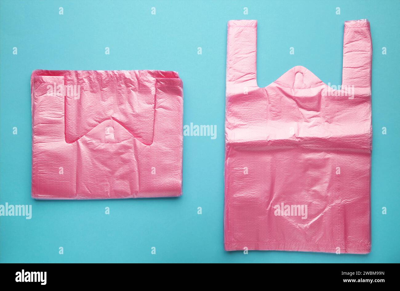 Punk plastic bags on blue background. Top view Stock Photo - Alamy