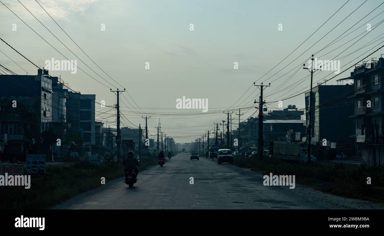 An isolated street is pictured with only a few people walking along the ...