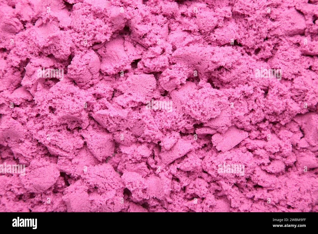 Background pink kinetic sand for children with copy space. Magic sand ...