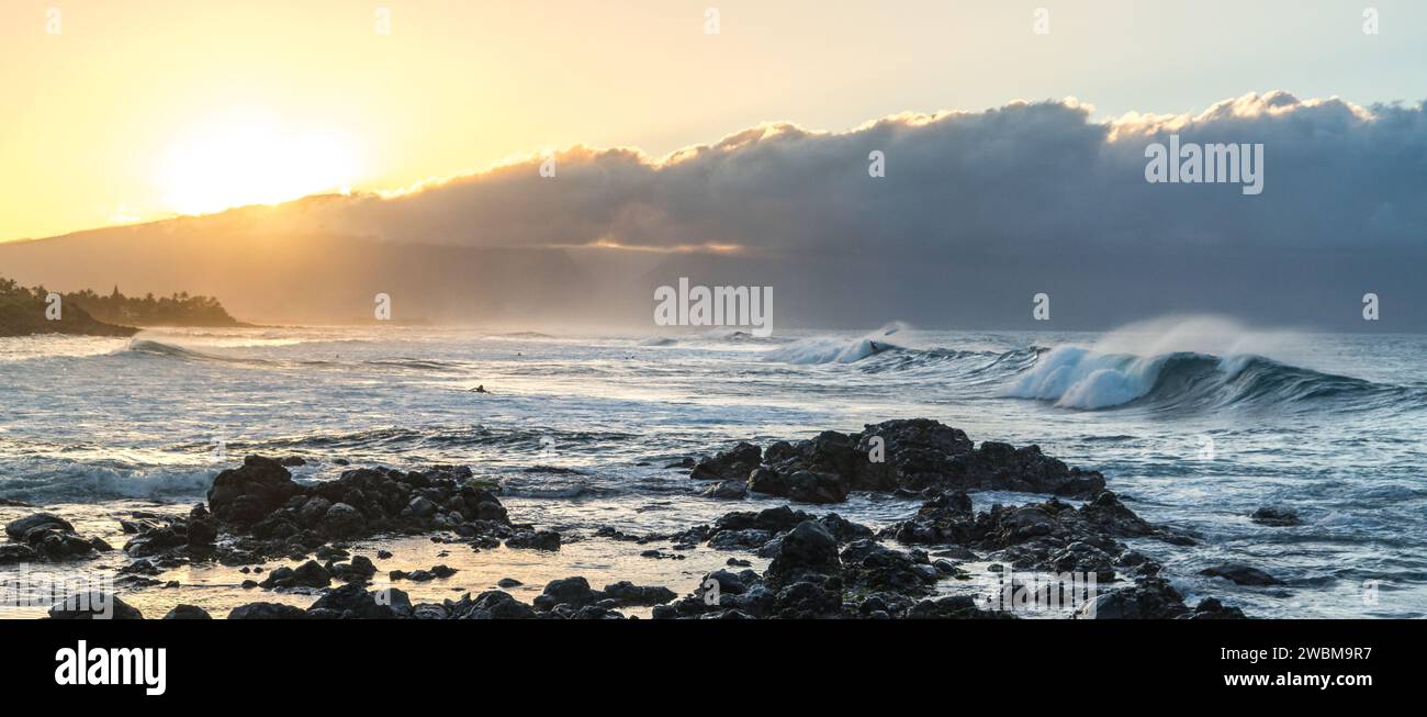 Sunset bath es Ho'okipa's shores in golden light as surfers and waves ...