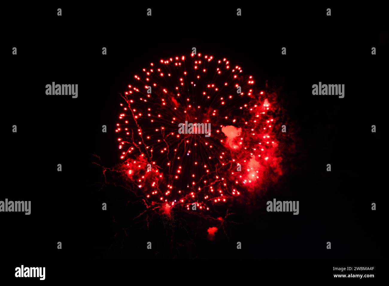 Red fireworks exploding in dark night sky, festive background concept ...