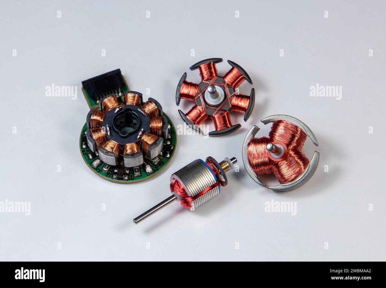 A close-up of a group of different electronic motor rotors on a white ...