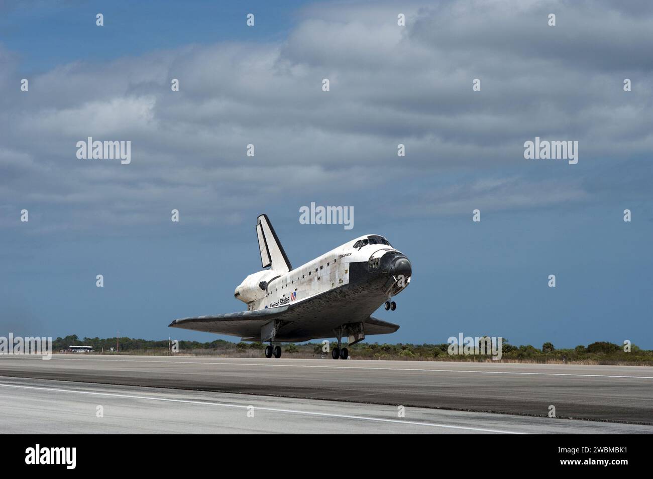 Space Shuttle Discovery's nose gear touches down on Runway 15 at ...