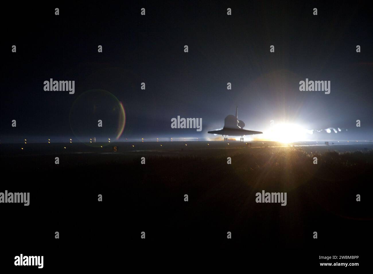 STS135-S-167 (21 July 2011) --- Xenon lights guide space shuttle ...