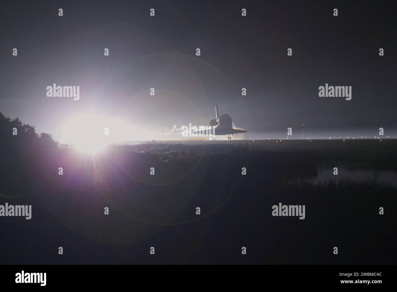 STS135-S-244 (21 July 2011) --- A halo of light engulfs space shuttle ...