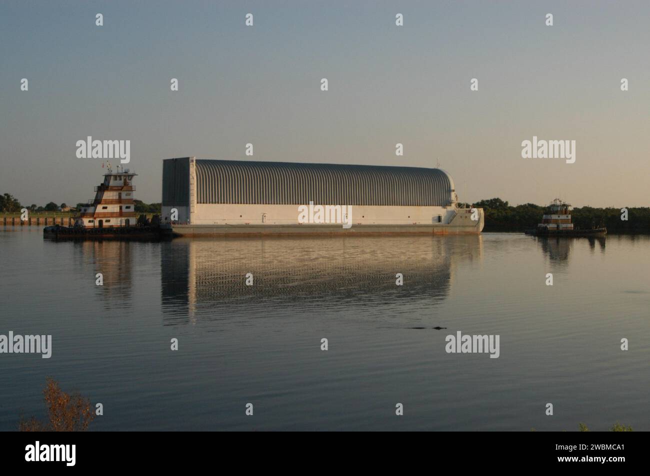 At the Turn Basin near Launch Complex 39, a tugboat moves NASA’s ...