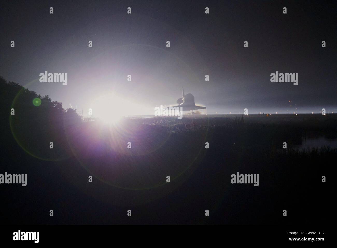 STS135-S-242 (21 July 2011) --- A halo of light engulfs space shuttle ...