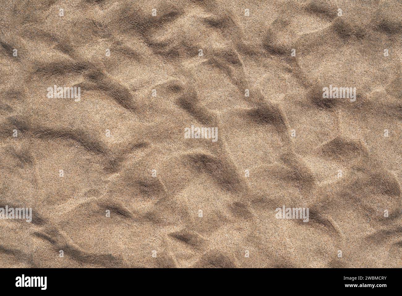 Fine brown sand with relief pattern on a beach in close-up Stock Photo ...