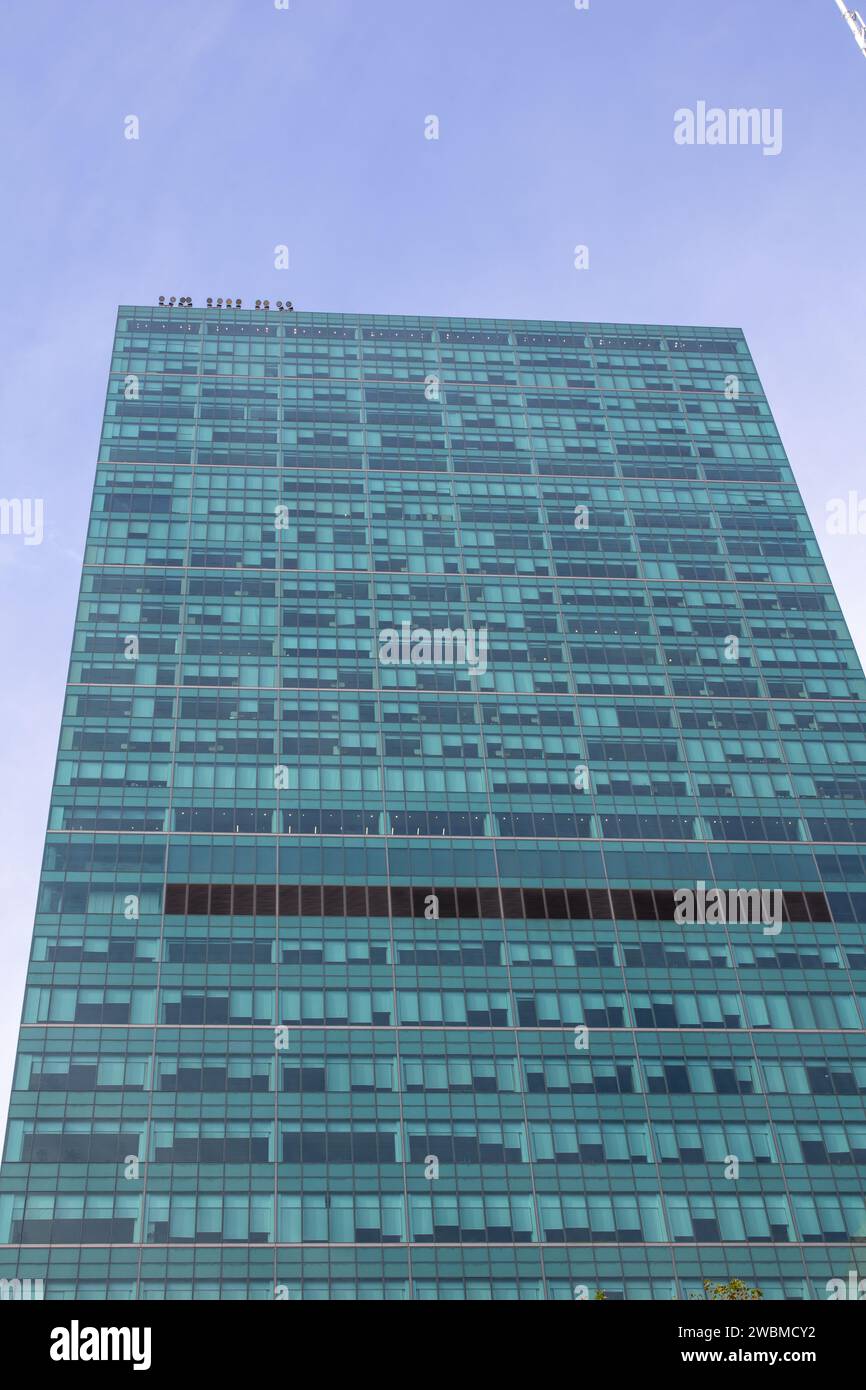 An aerial view of a modern glass skyscraper located in an urban ...