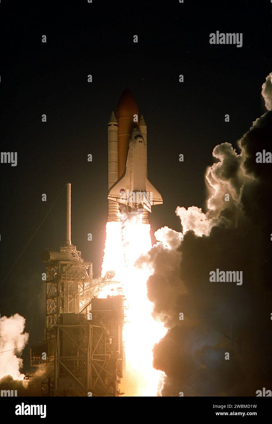 KENNEDY SPACE CENTER, FLA. -- Trailing a column of flame-bright smoke ...