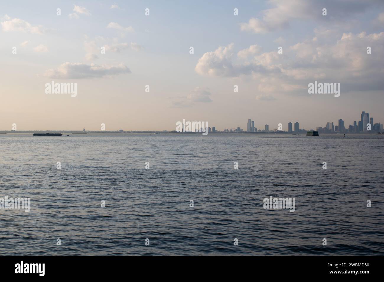 An idyllic sunset view of a bustling city skyline reflected in the ...