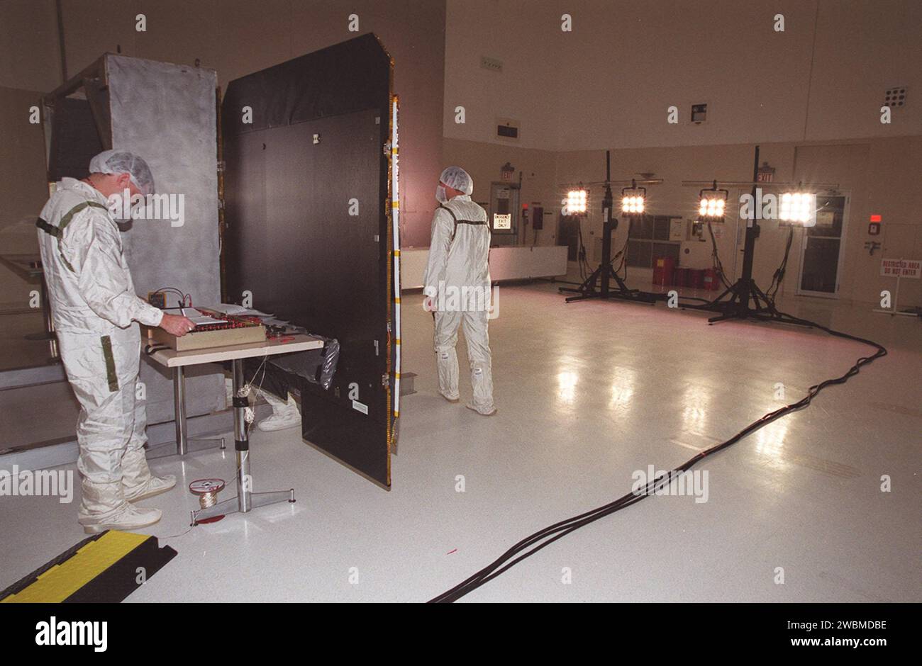 A worker (left) records data during illumination testing on the Mars ...