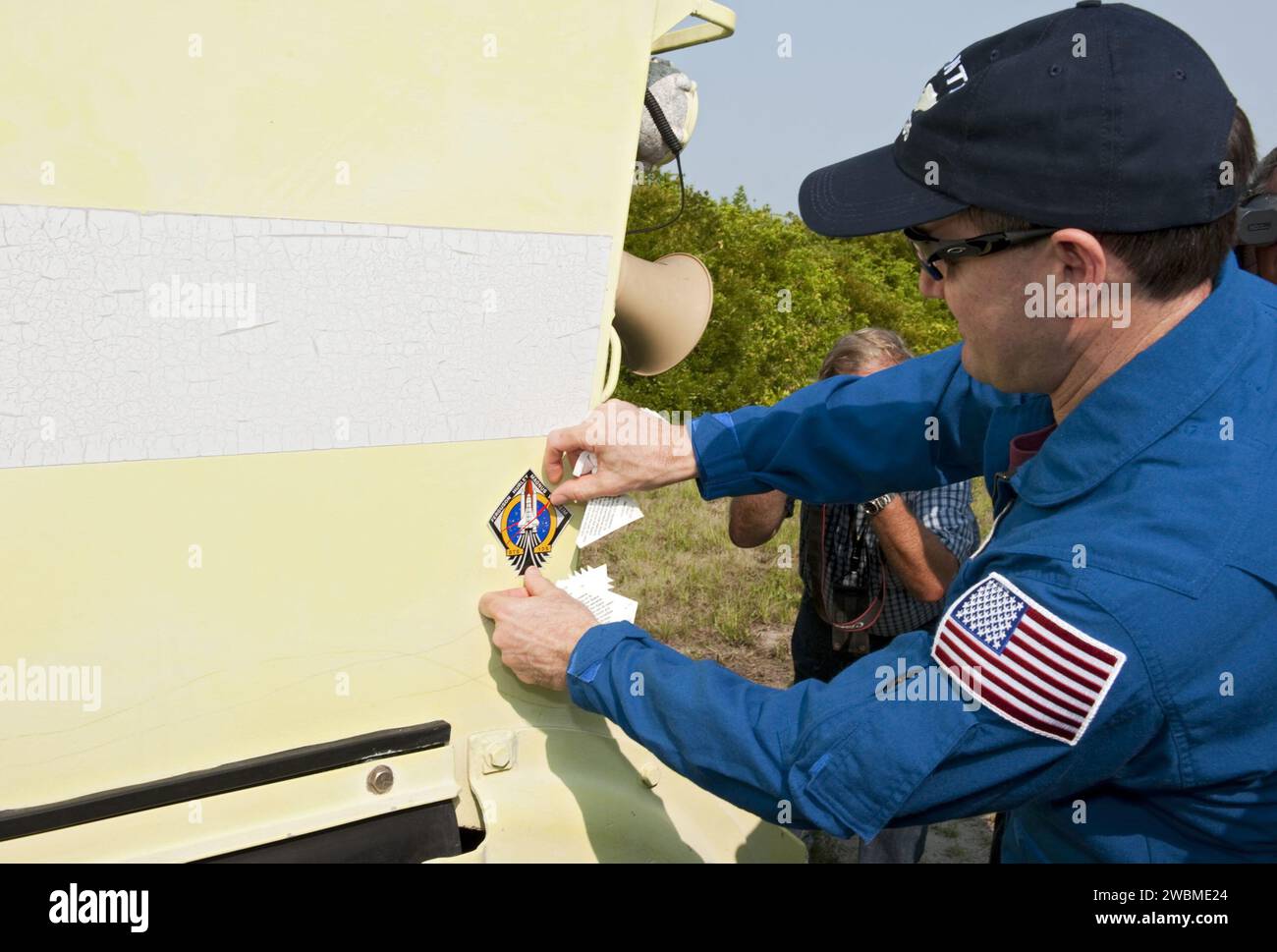 CAPE CANAVERAL, Fla. -- Mission Specialist Rex Walheim affixes his ...