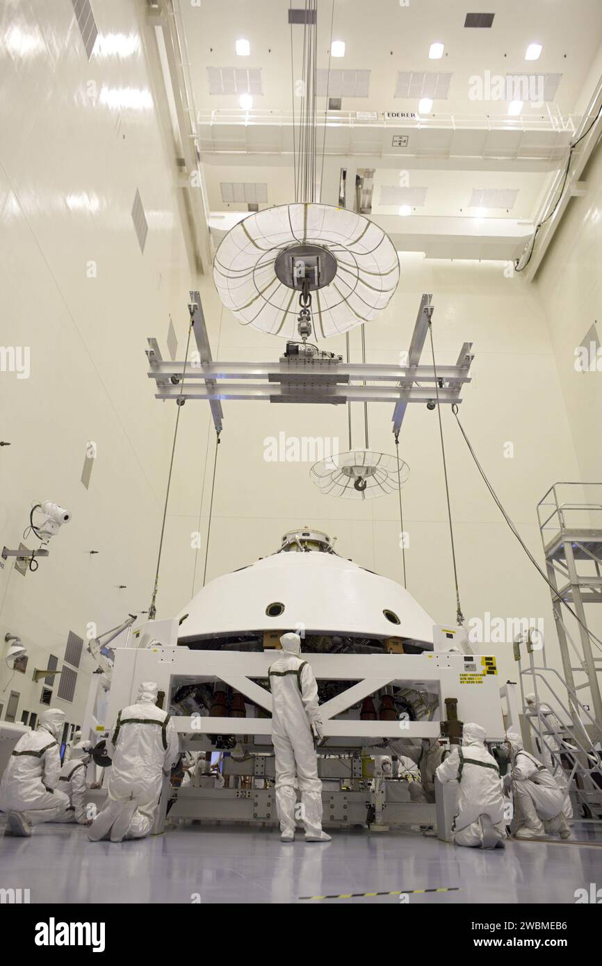 Technicians at Kennedy Space Center inspect the backshell placement ...