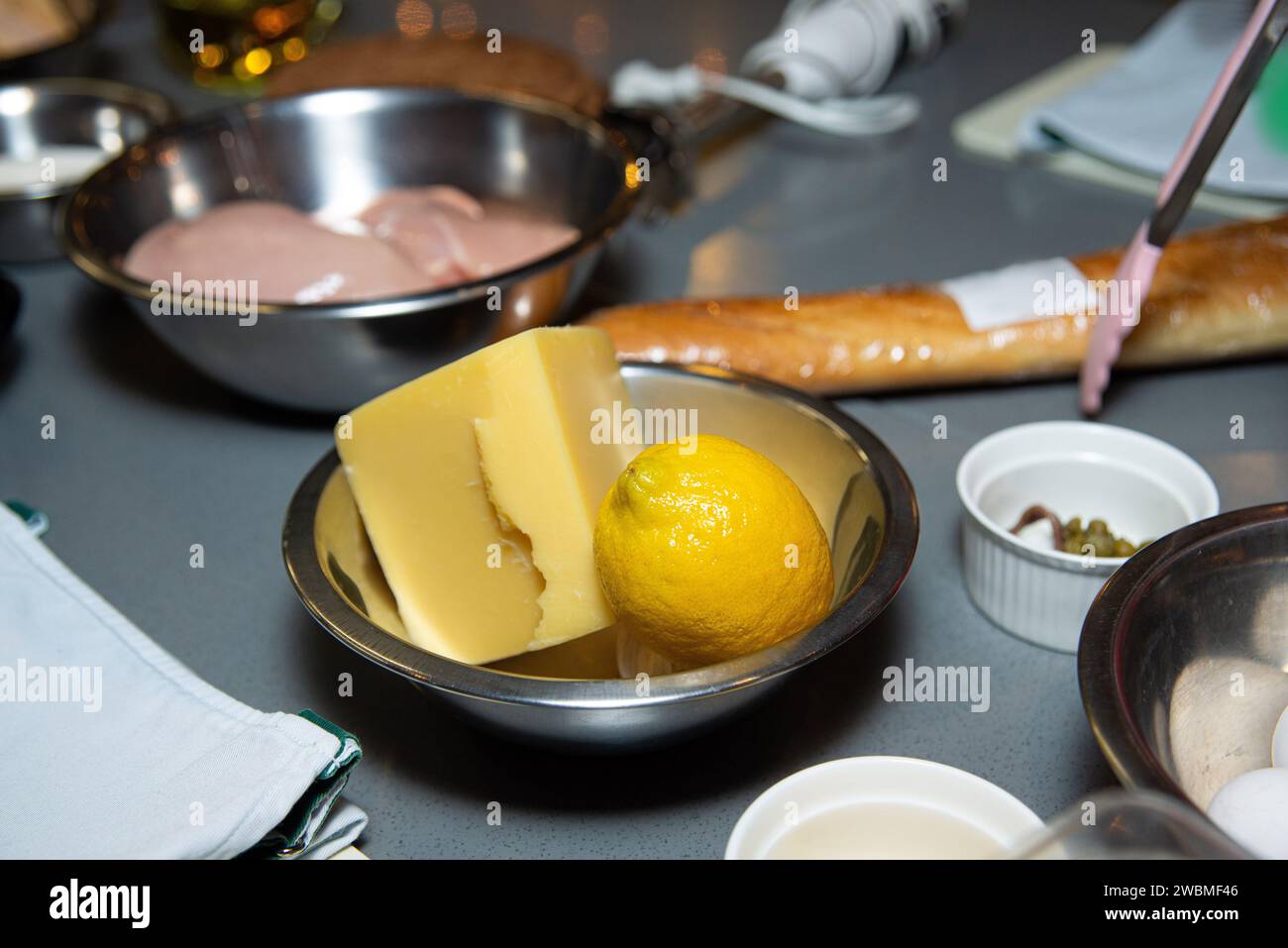 Various cooking ingredients including cheese, lemon, and chicken laid ...