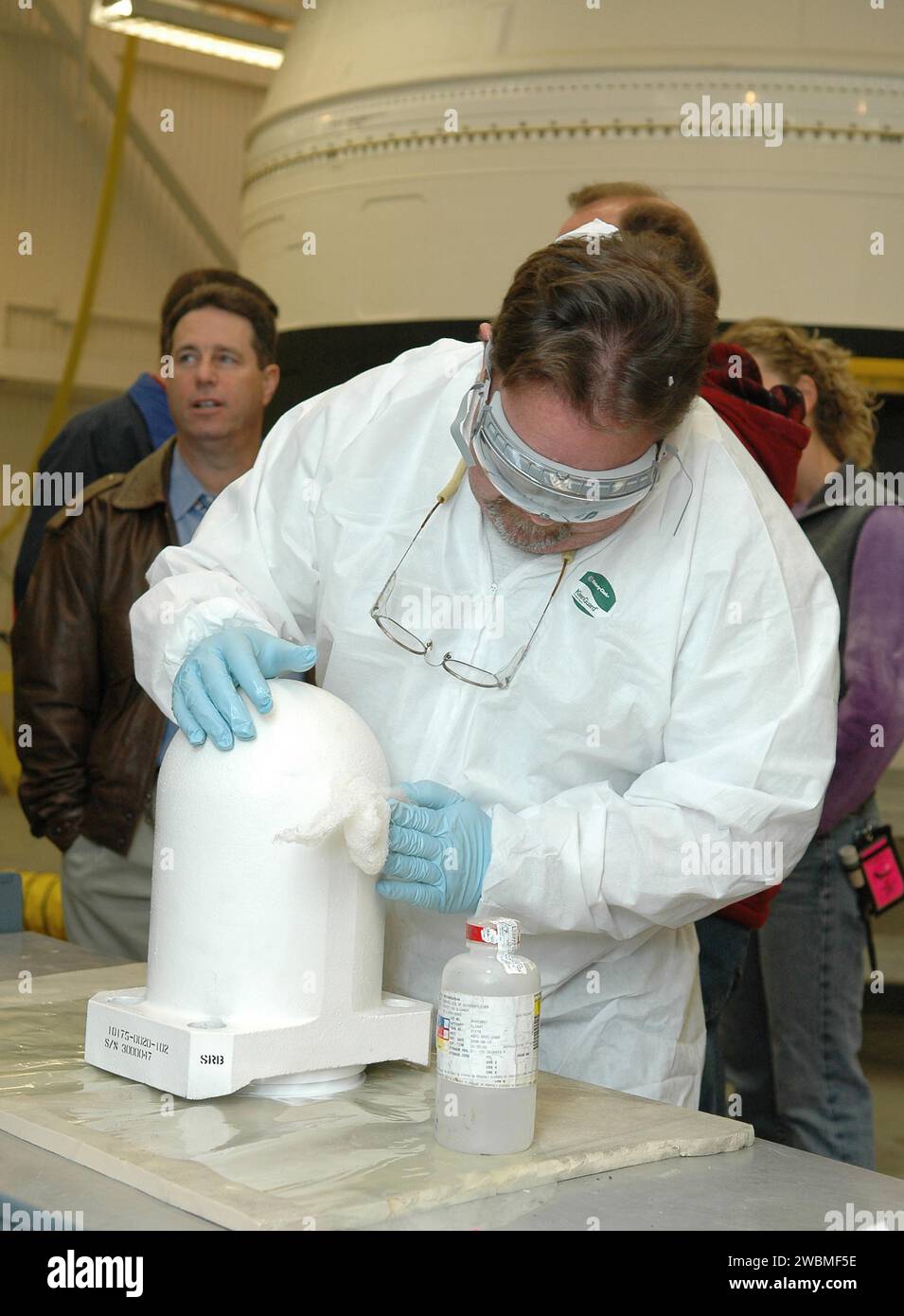 A senior technician at Kennedy Space Center prepared one of two bolt ...