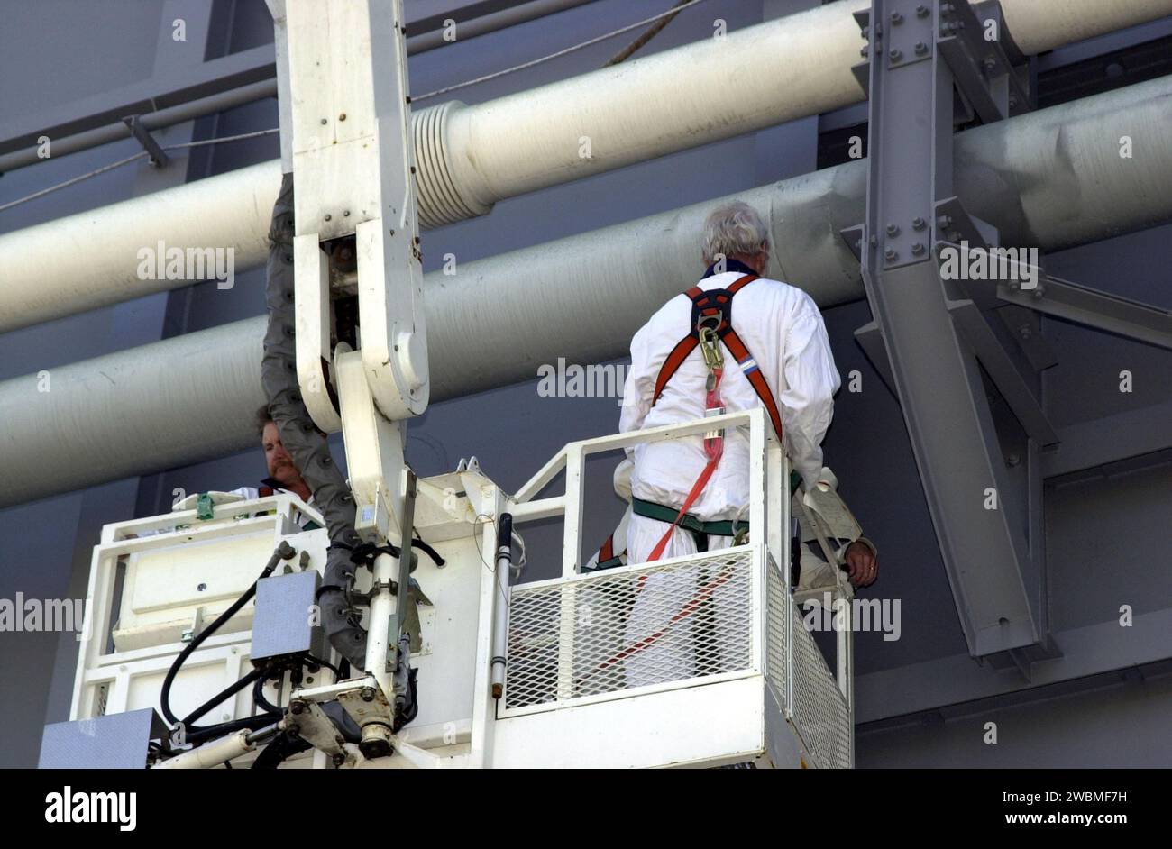 KENNEDY SPACE CENTER, FLA. -- At Launch Pad 39B, a worker on a crane ...