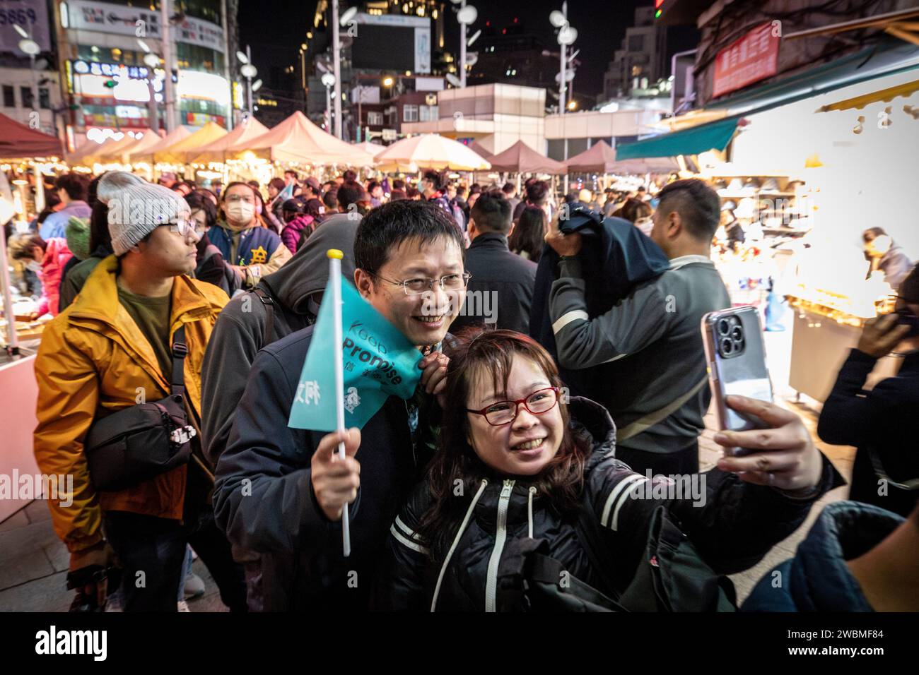 Taiwan, Jan 11, 2024. Supporters were taking a selfie during queuing up ...