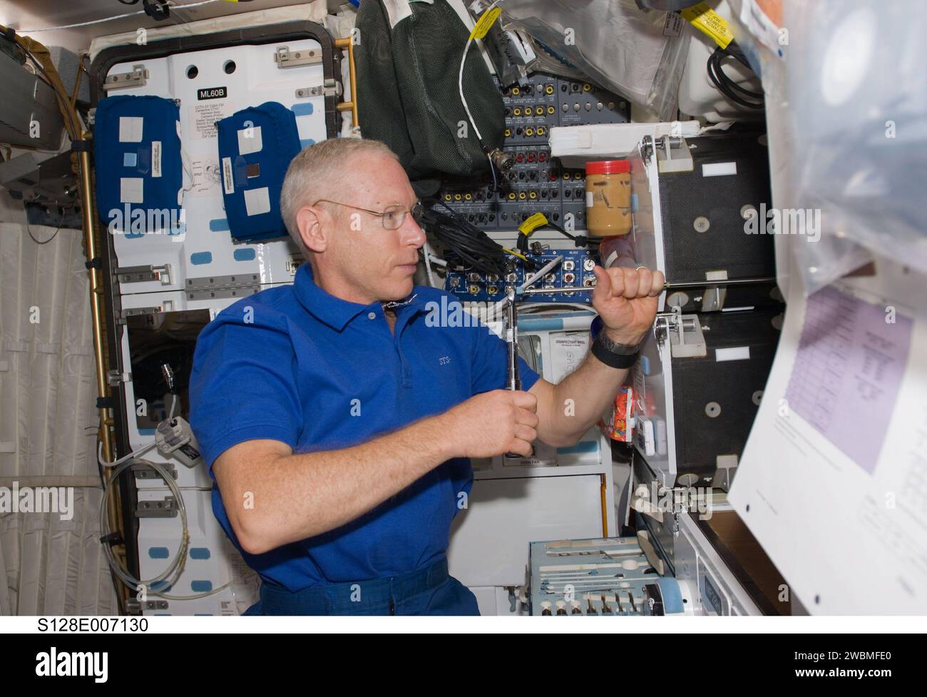 Astronaut Patrick Forrester, STS-128 mission specialist, performs tasks ...