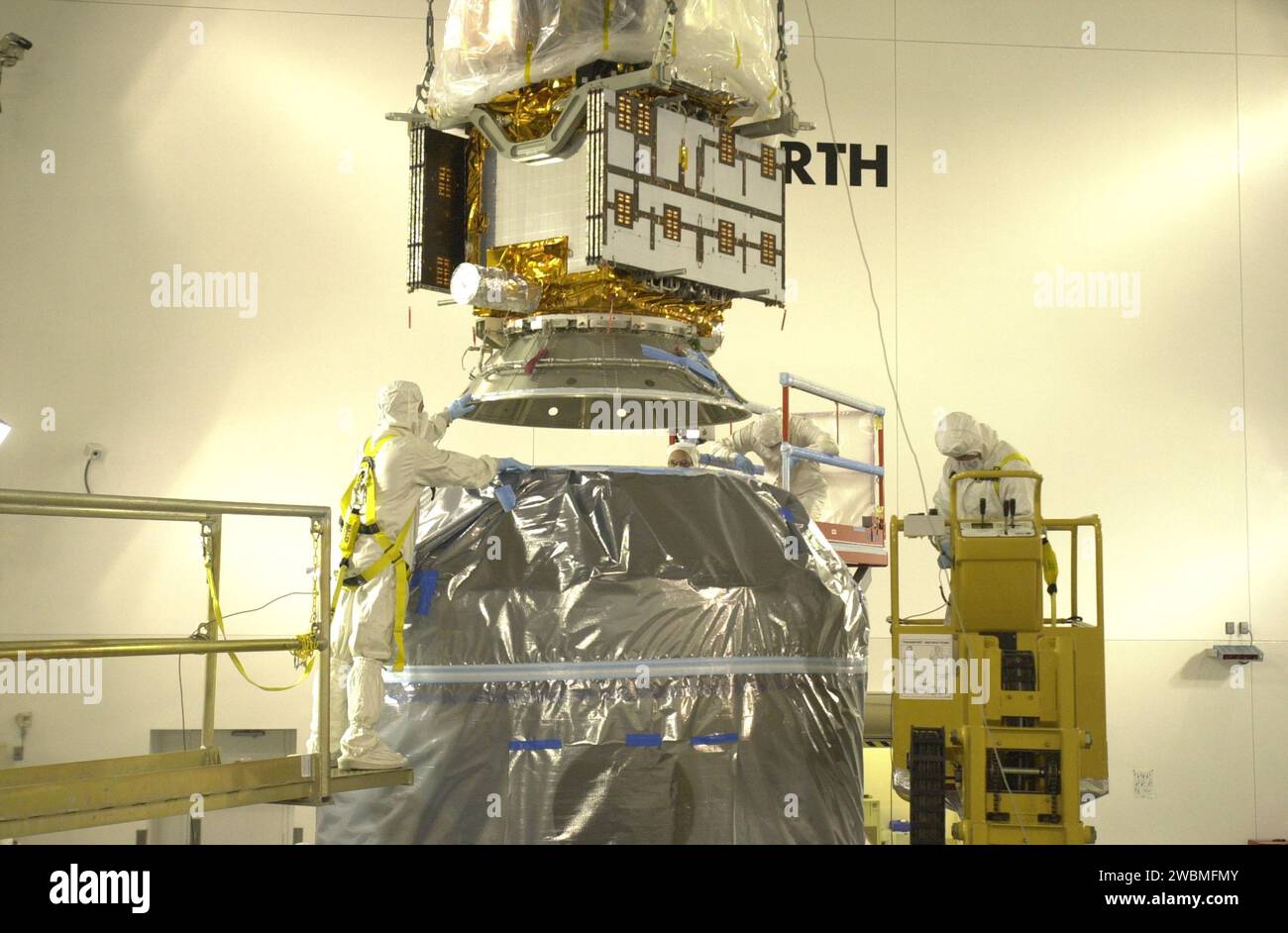 Workers at Vandenberg lower the CALIPSO spacecraft with UDPAF toward ...