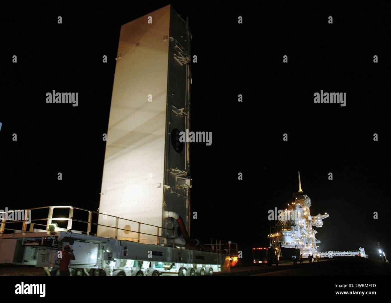 KENNEDY SPACE CENTER, FLA. - In the dark before dawn, the payload canister carrying payloads ...