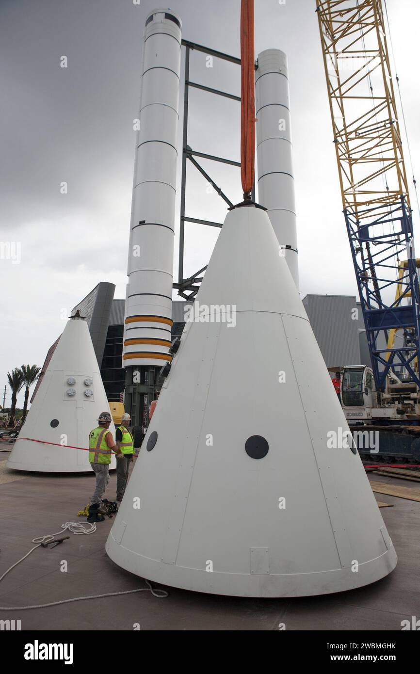CAPE CANAVERAL, Fla. – Workers prepare to lift a nose cone to top out ...