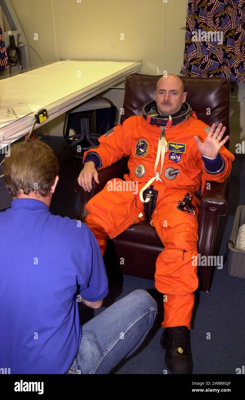 KENNEDY SPACE CENTER, Fla. -- STs-108 Pilot Mark E. Kelly is helped ...