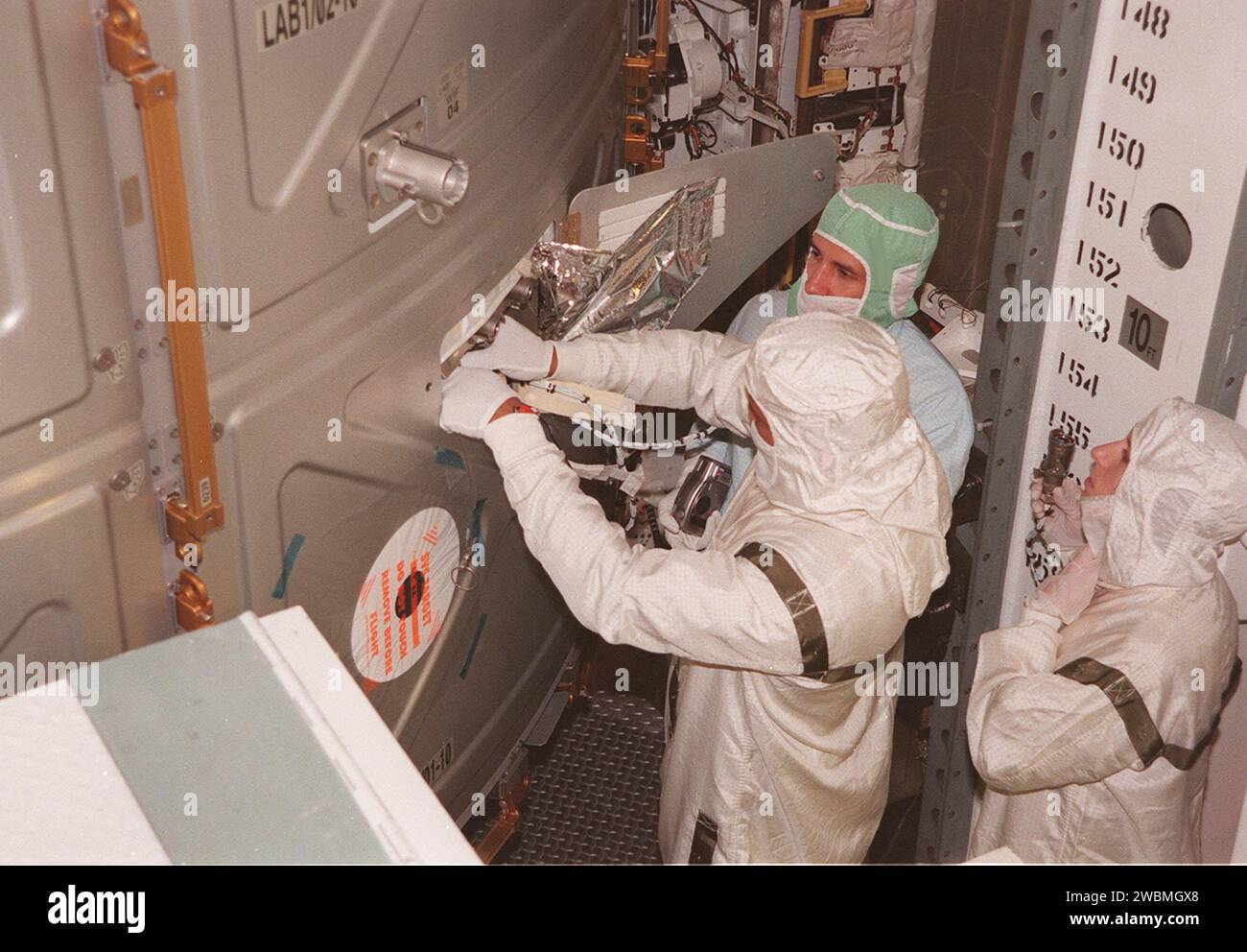 KENNEDY SPACE CENTER, FLA. -- In the payload bay of Atlantis, two workers (background and right ...
