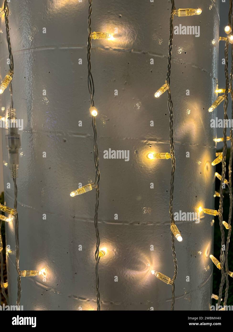 A white light fixture hangs from the exterior of a contemporary modern ...