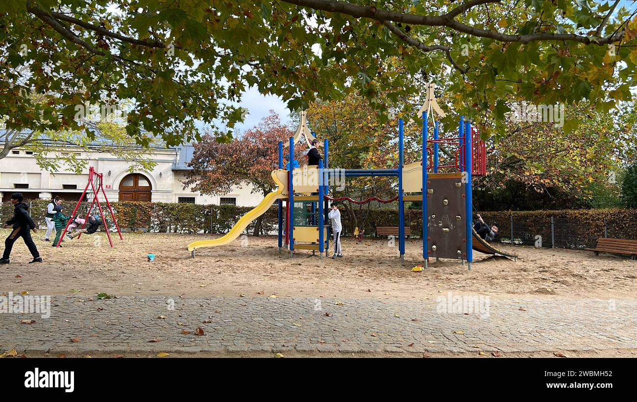 A brightly colored children's playground surrounded by lush green grass ...