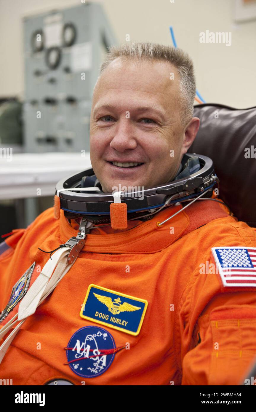 At NASA Kennedy Space Center, STS-135 Pilot Doug Hurley checks his ...