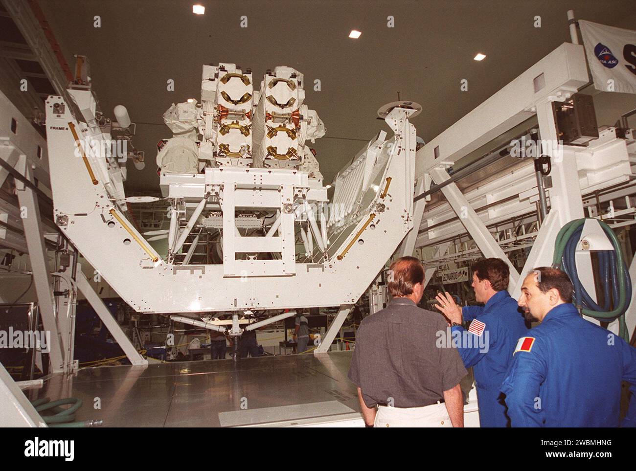 KSC’s PAO videographer, Glenn Benson (left) listens to STS-100 Pilot ...