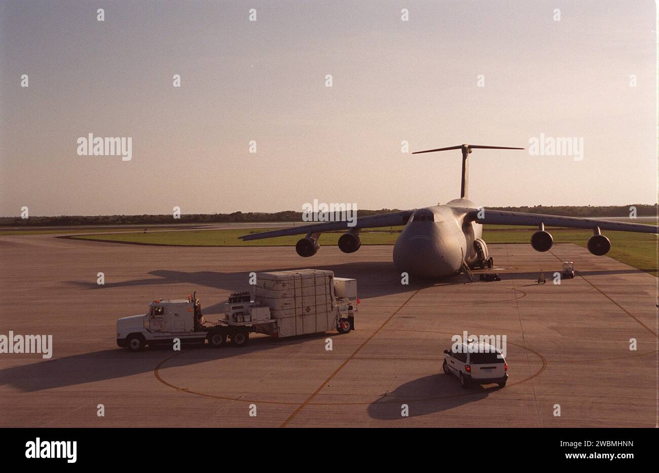 At the KSC Shuttle Landing Facility, the GOES-M satellite, encased in a ...