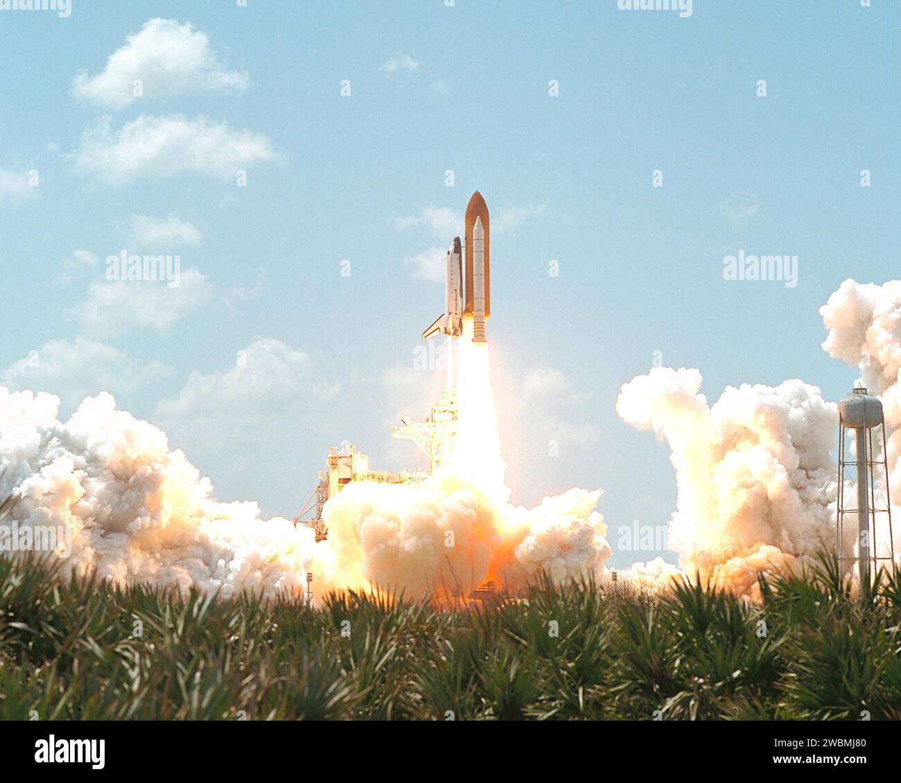 KENNEDY SPACE CENTER, FLA. -- Through a cloud-brushed blue sky, Space Shuttle Endeavour is ...