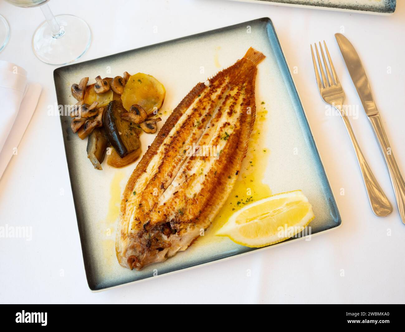 Roasted black sole fish with stewed vegetables and lemon Stock Photo ...