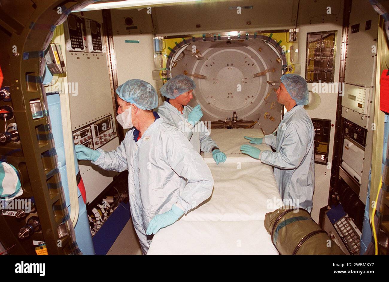 KENNEDY SPACE CENTER, FLA. -- Members of the STS-104 crew look over ...