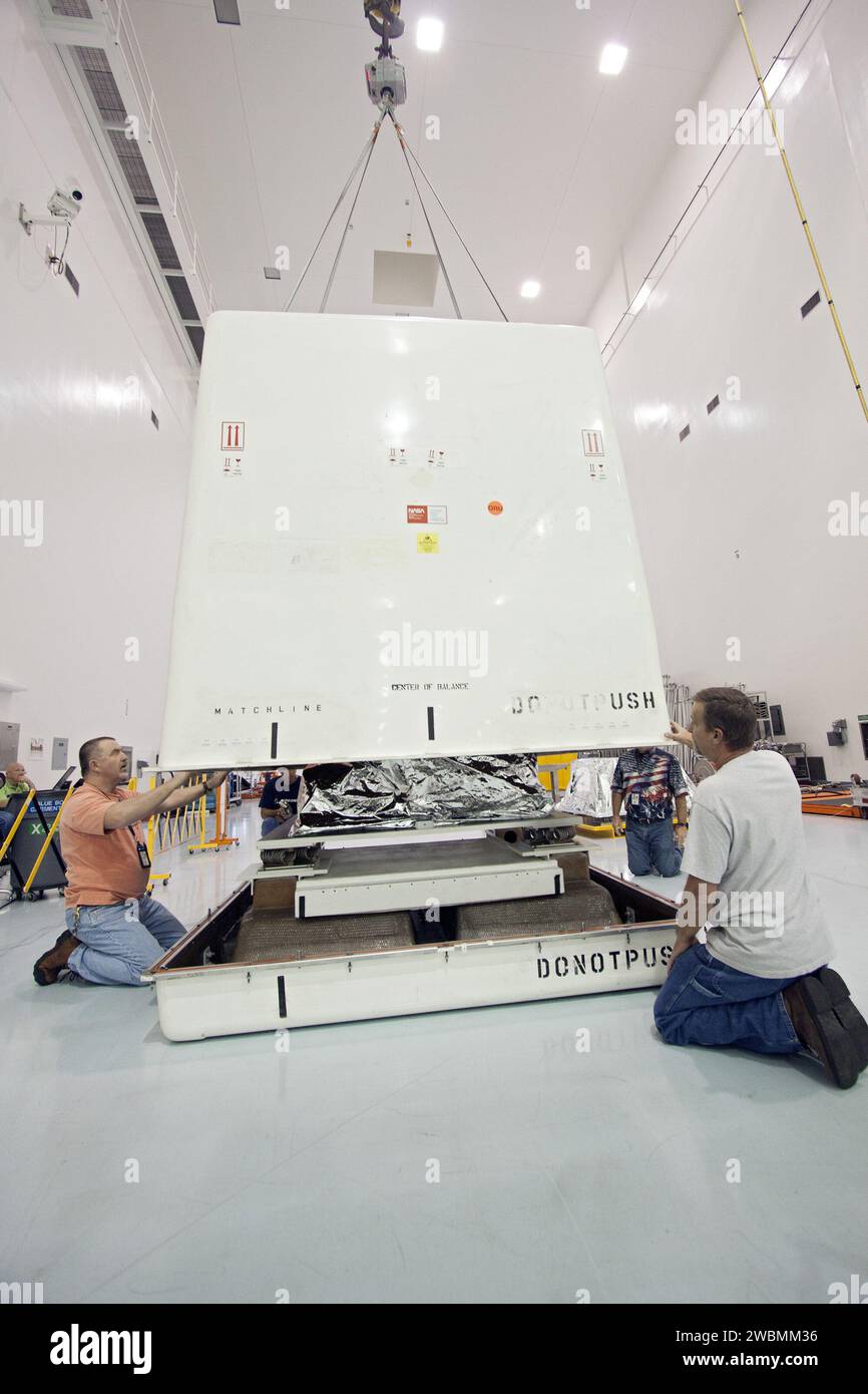 Technicians at NASA’s Kennedy Space Center prepare the orbital ...