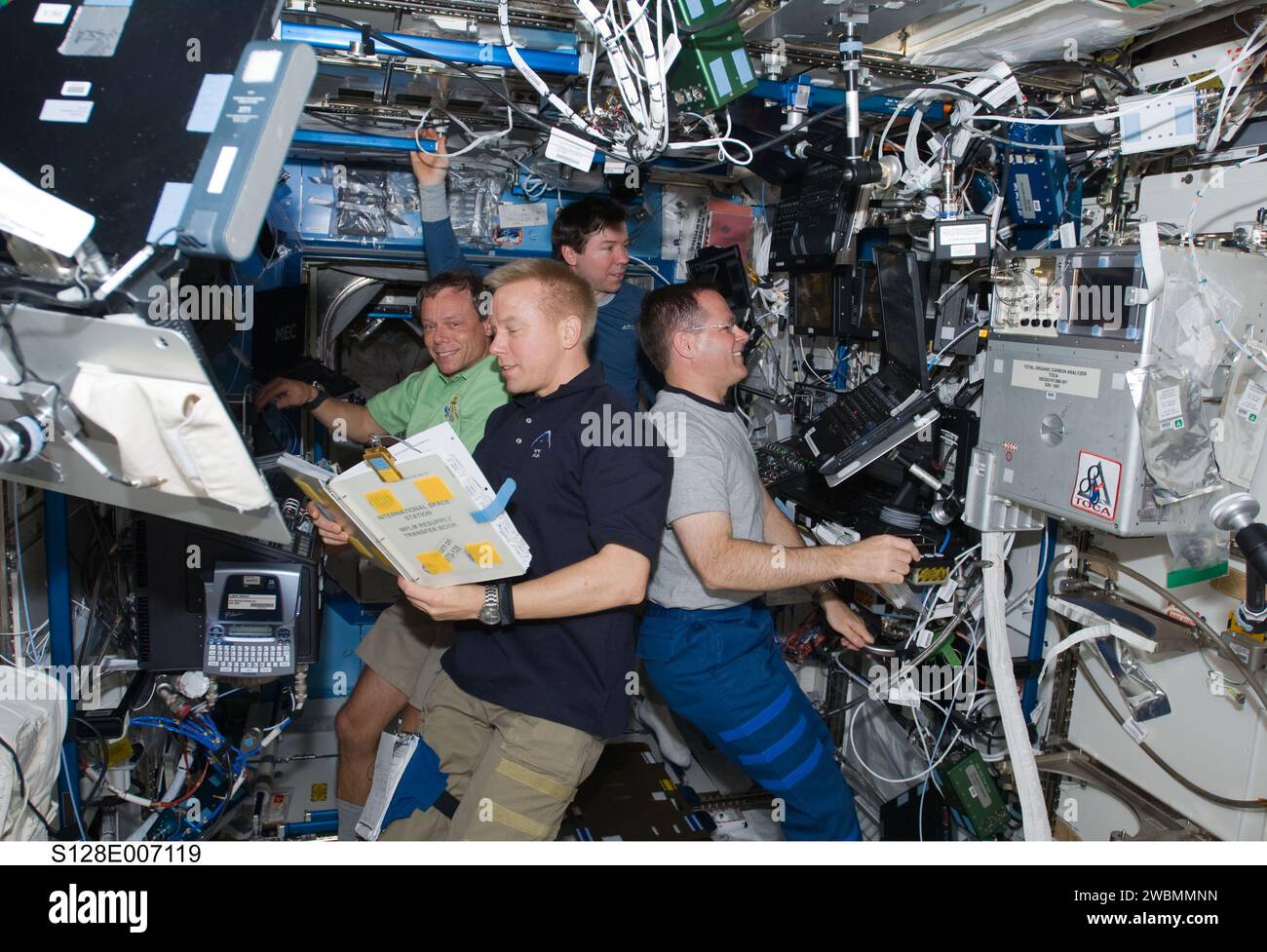 S128-E-007119 (31 Aug. 2009) --- NASA astronaut Tim Kopra (left ...