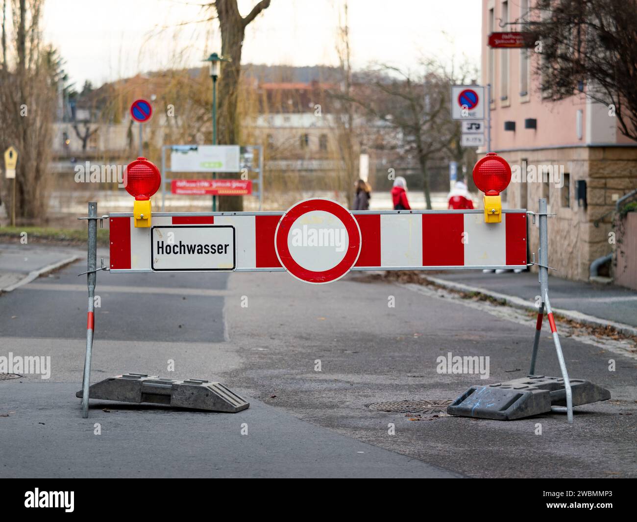 Hochwasser (floods) sign at a barrier. The street is closed because of ...