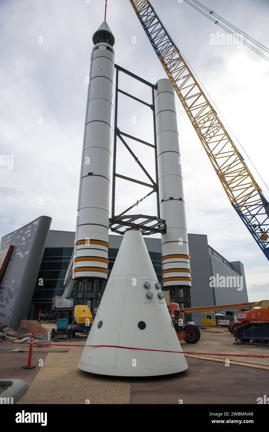 CAPE CANAVERAL, Fla. – A crane lifts a nose cone to top out one of a pair of replica space ...