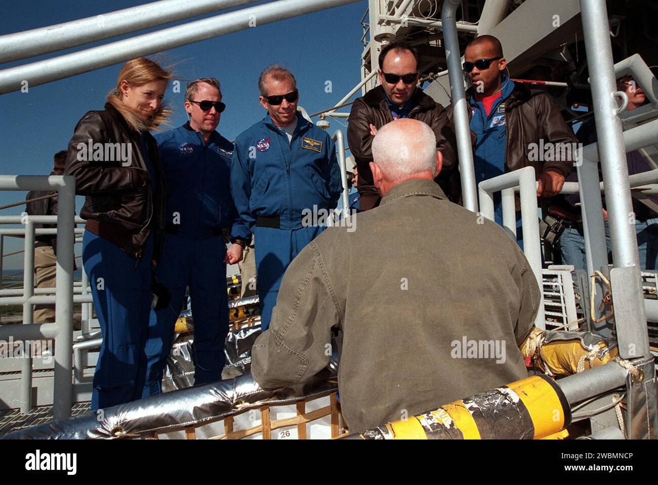 The STS-98 crew listens to instructions on use of the slidewire basket, part of emergency egress ...