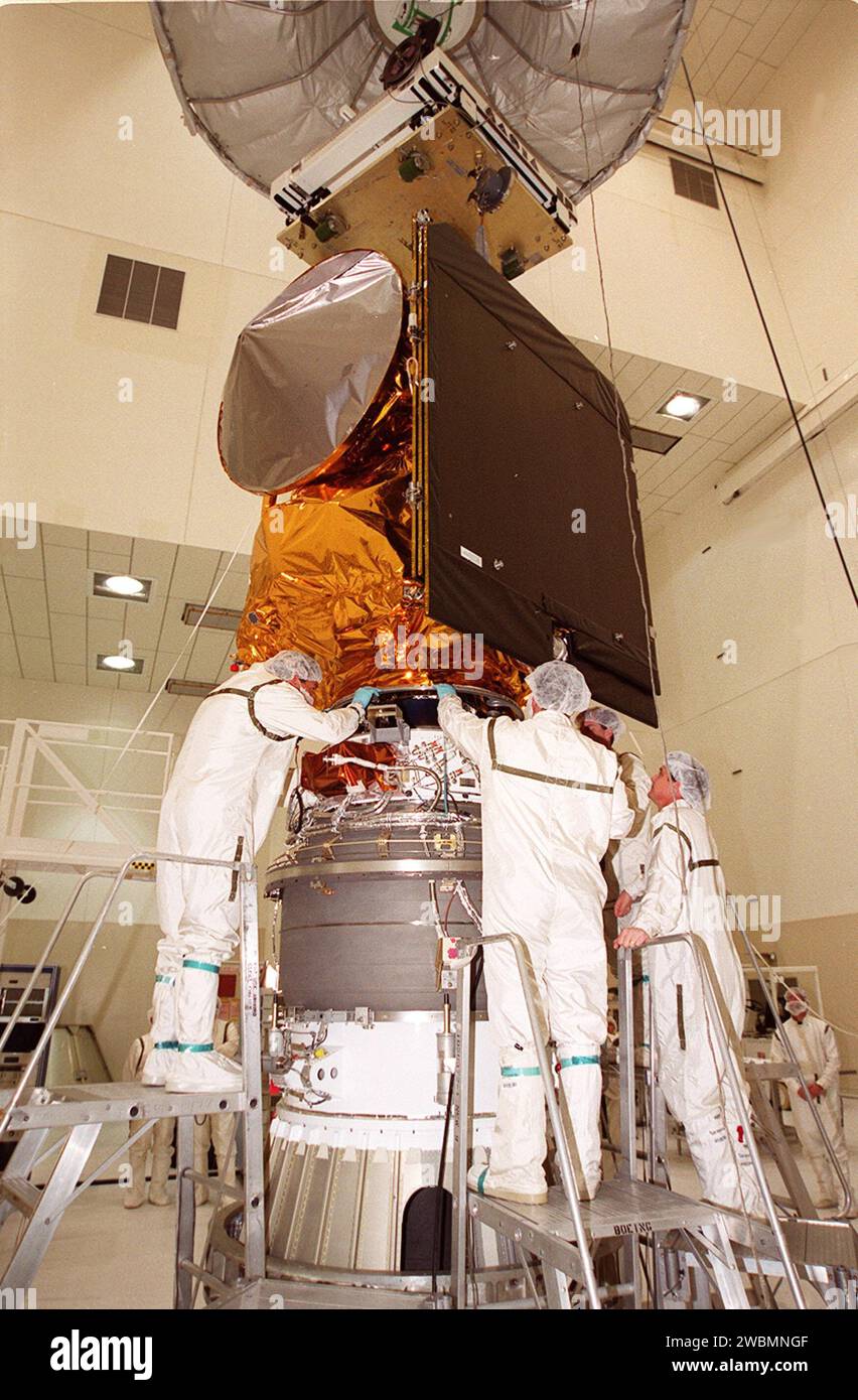 Workers in the Space Assembly and Encapsulation Facility 2 check the ...