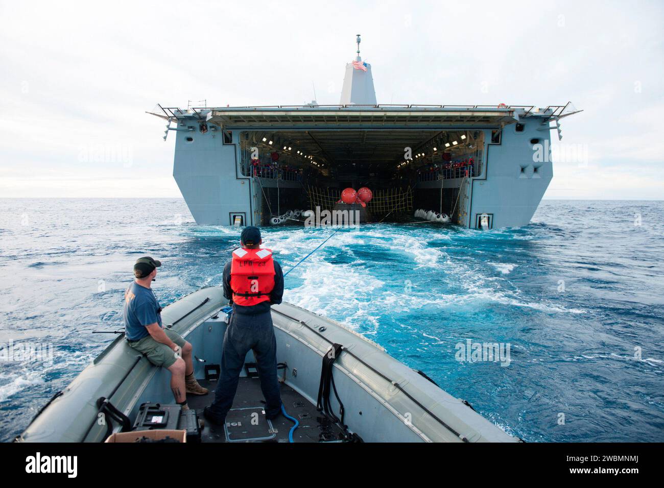 Recovery team members in a Zodiac boat help guide NASA's Orion ...