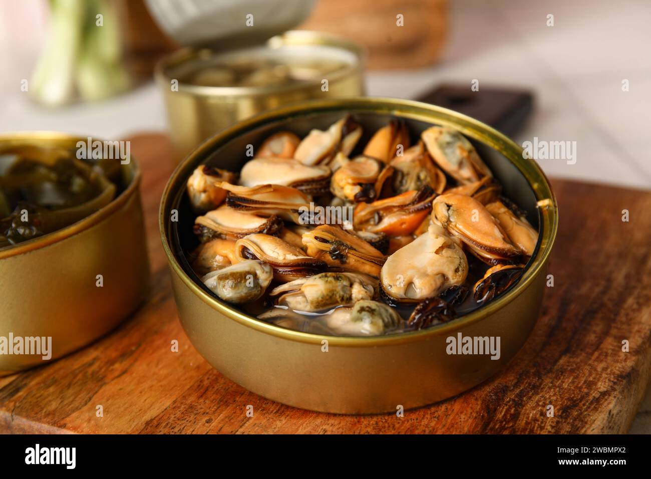 Board with opened tin can of mussels, closeup Stock Photo - Alamy